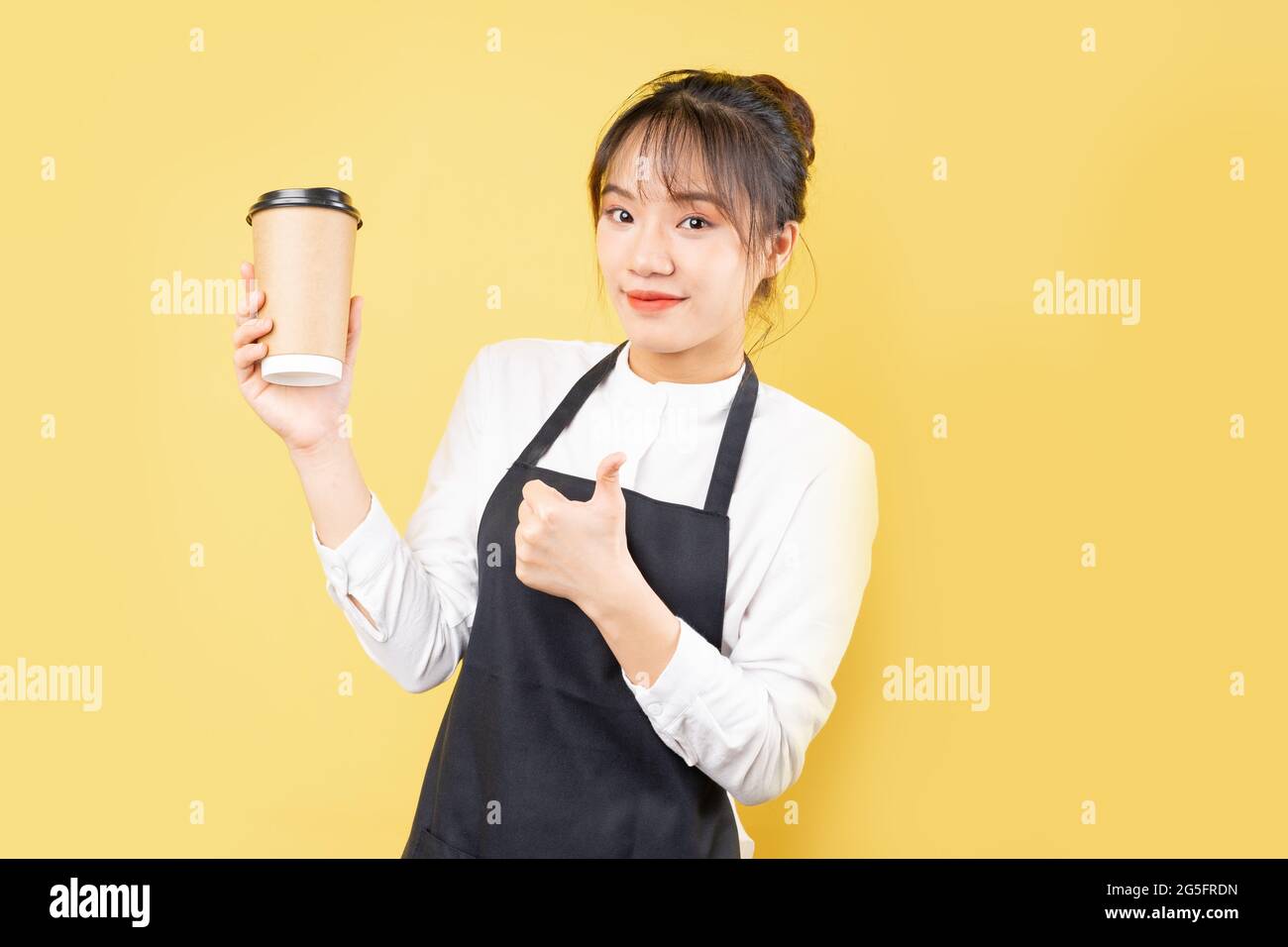 Portrait of cheerful waitress on yellow background Stock Photo - Alamy