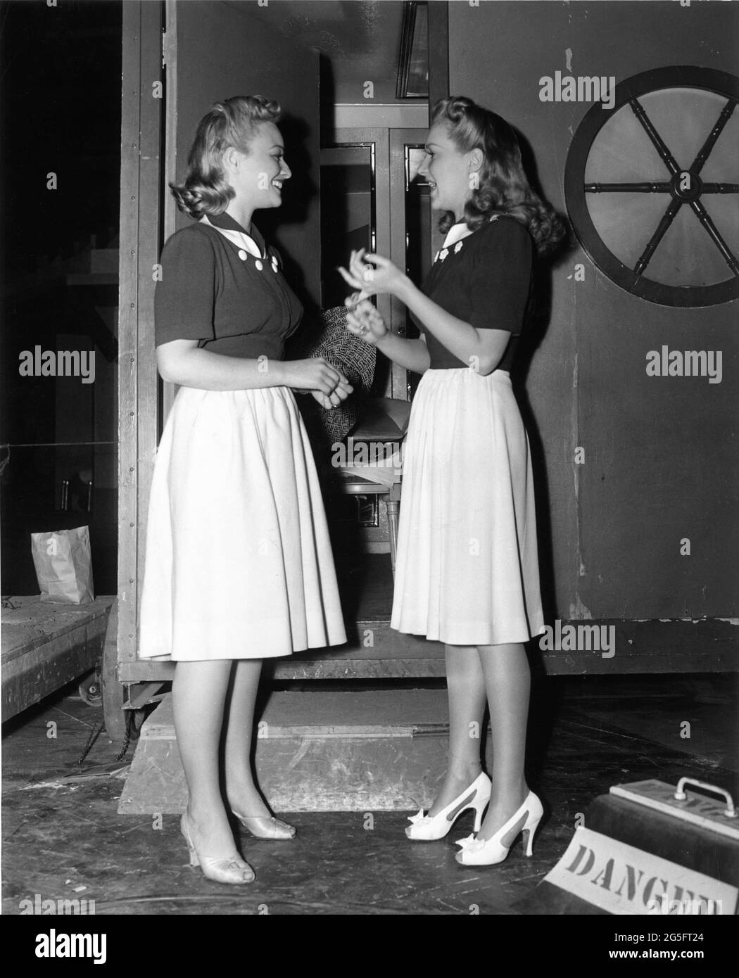 BETTY GRABLE (at right) with her Stand-In BOBBIE COLEMAN on set candid ...