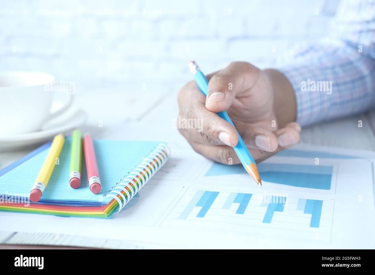 man hand with pen analyzing bar chart on paper Stock Photo - Alamy