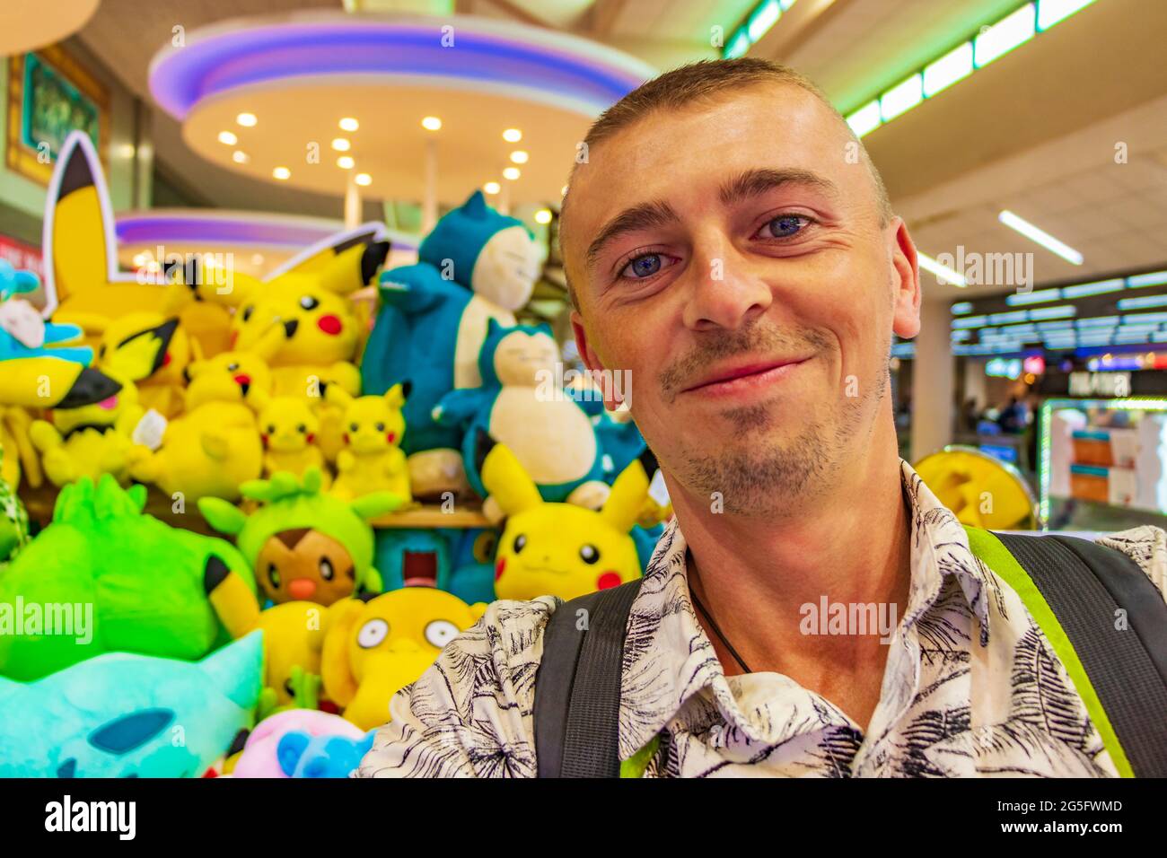 Tourist with colorful Pokemon Pikachu plush toys in Bangkok airport ...