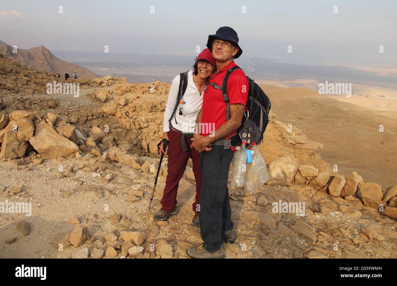 Married man & woman hikers, senior adults, she leans on his shoulders ...