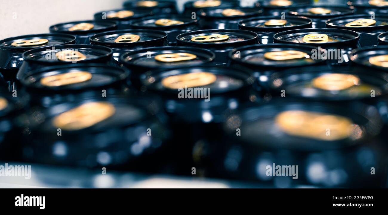 production line of drinks in black tin cans Stock Photo - Alamy