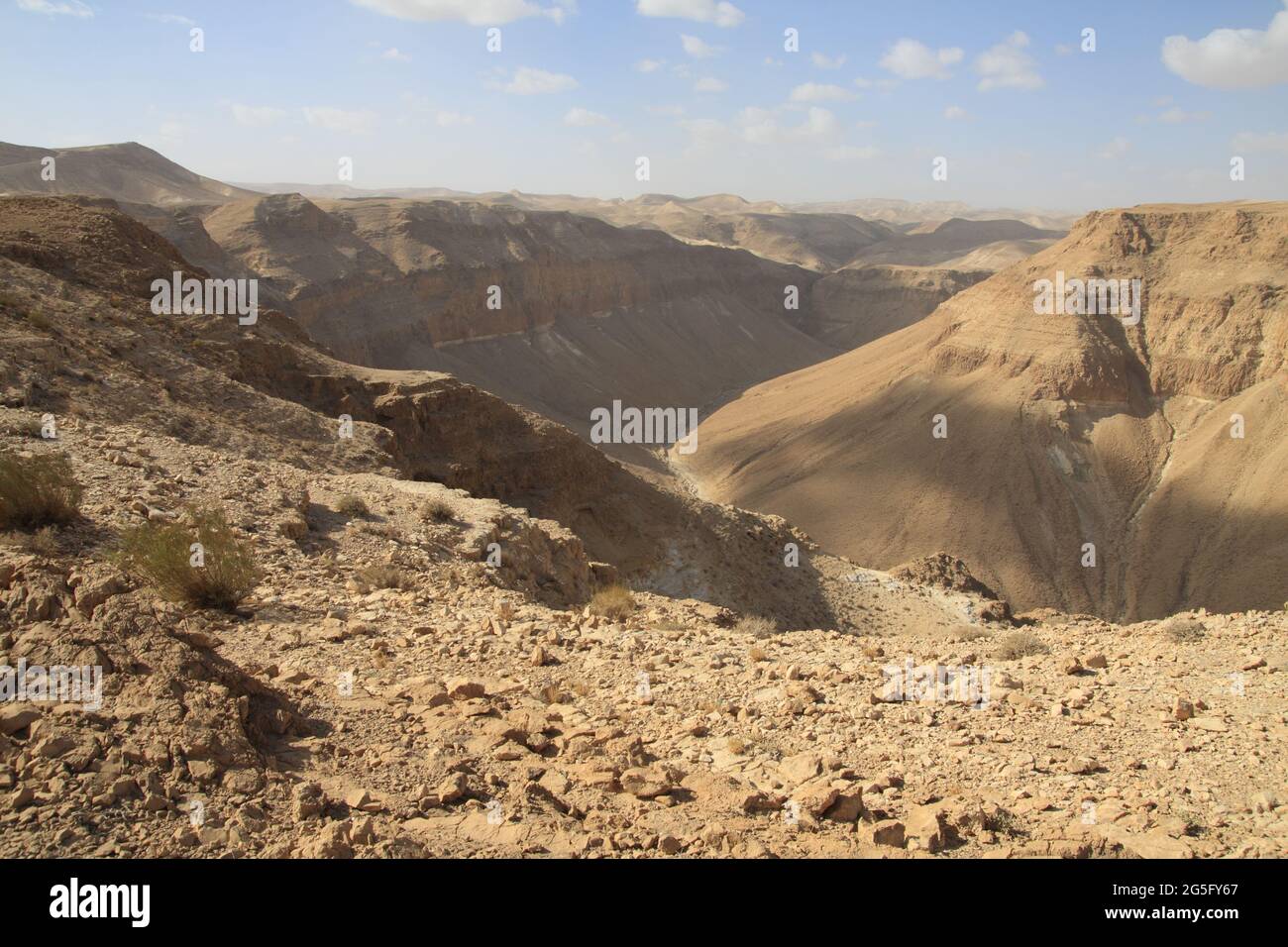 View from the edge of a cliff overlooking the rugged terrain, the ...