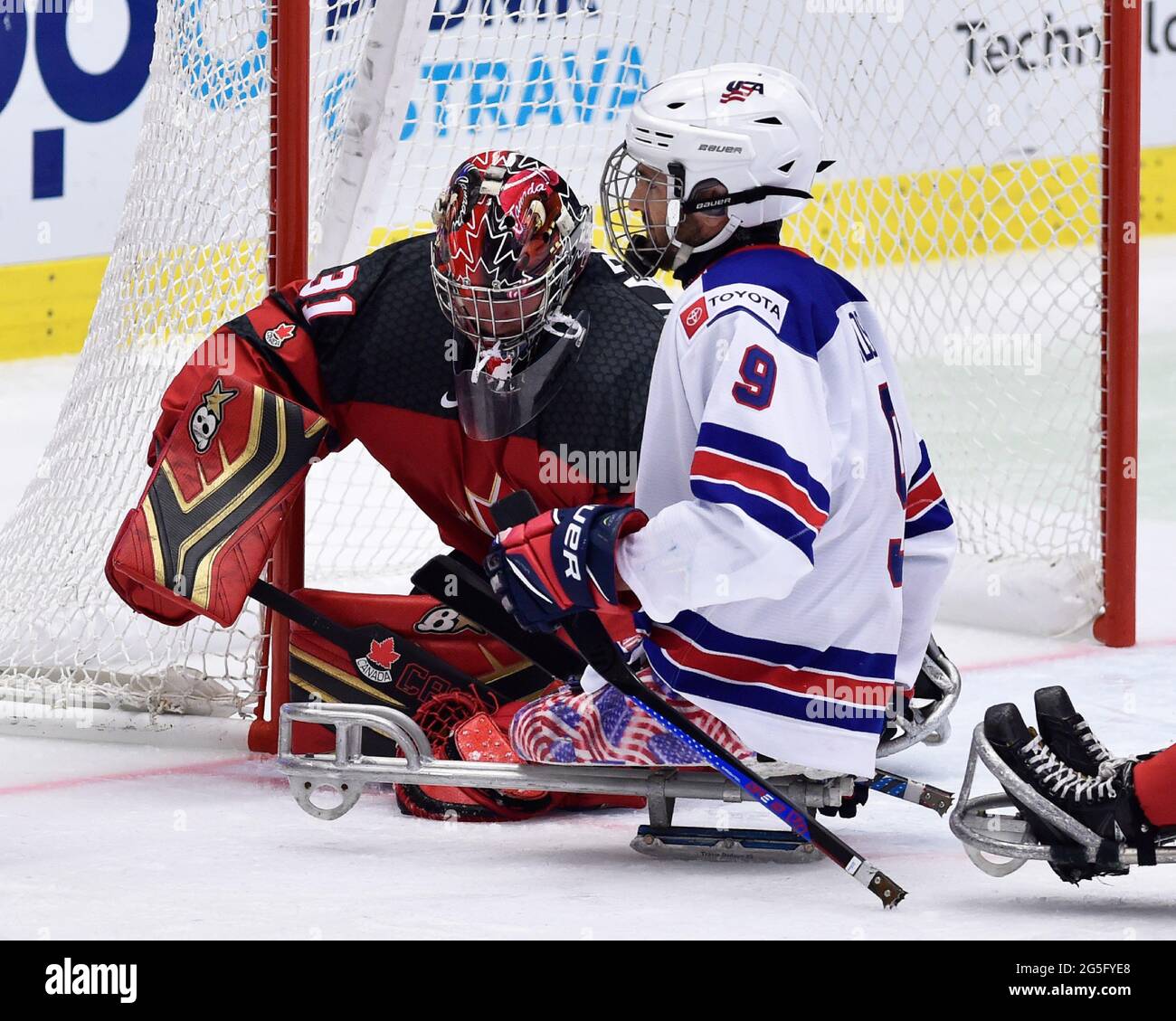 Dominic Larocque, goalkeeper of Canada, left, and Travis Dodson of USA ...