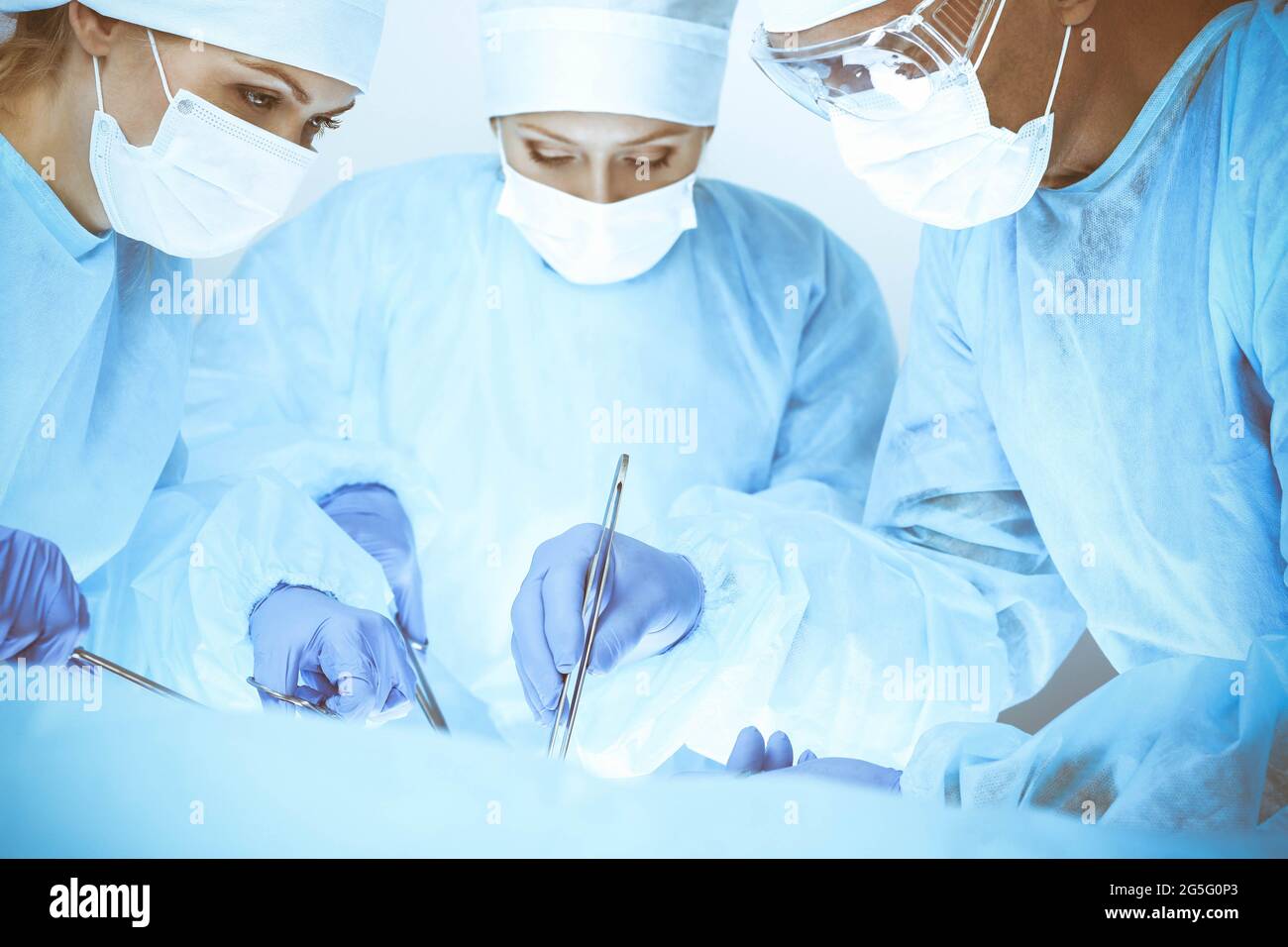 A group of surgeons is operating at the hospital. Health care concept ...