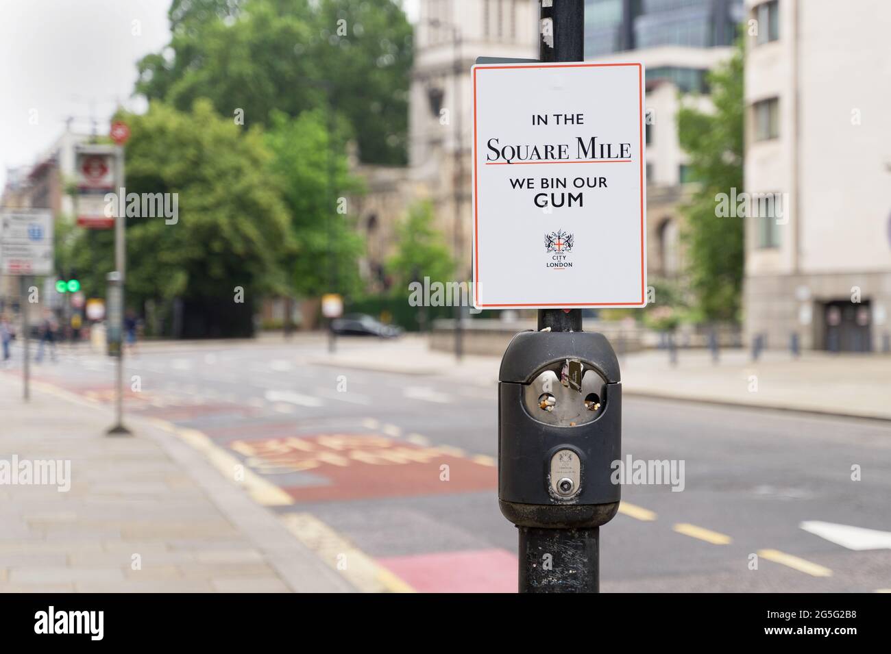 A City of London chewing gum and cigarette bin on a lamppost with a ...