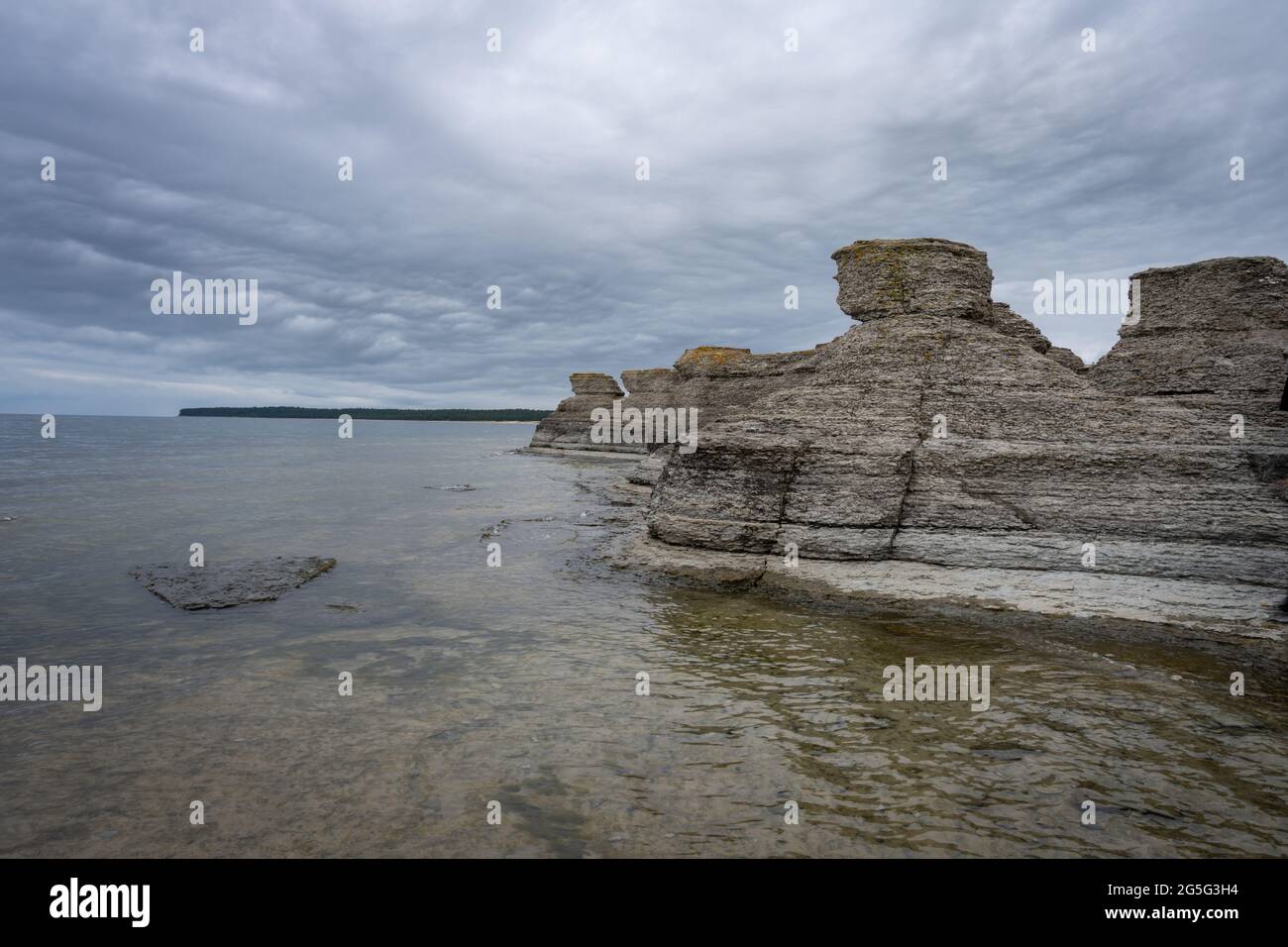 A beautiful limestone formation with a dramatic sky in the background ...