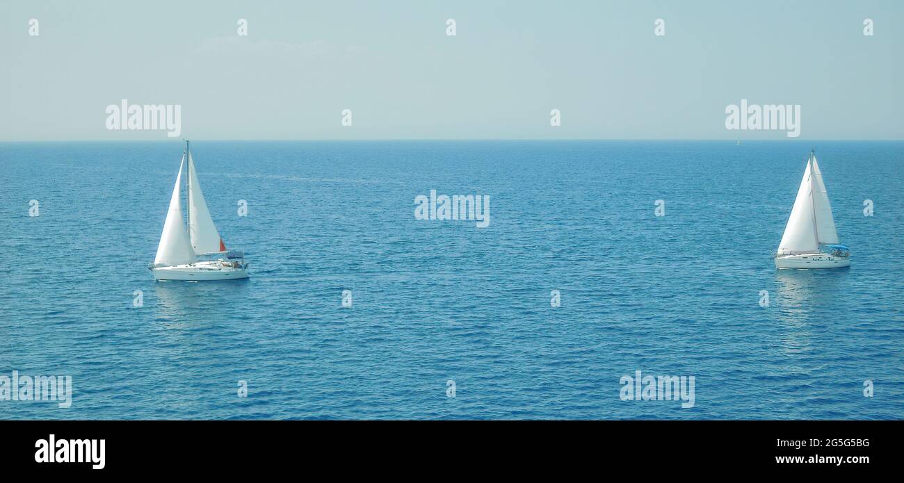 Two ships with sails cruise the sea Stock Photo - Alamy