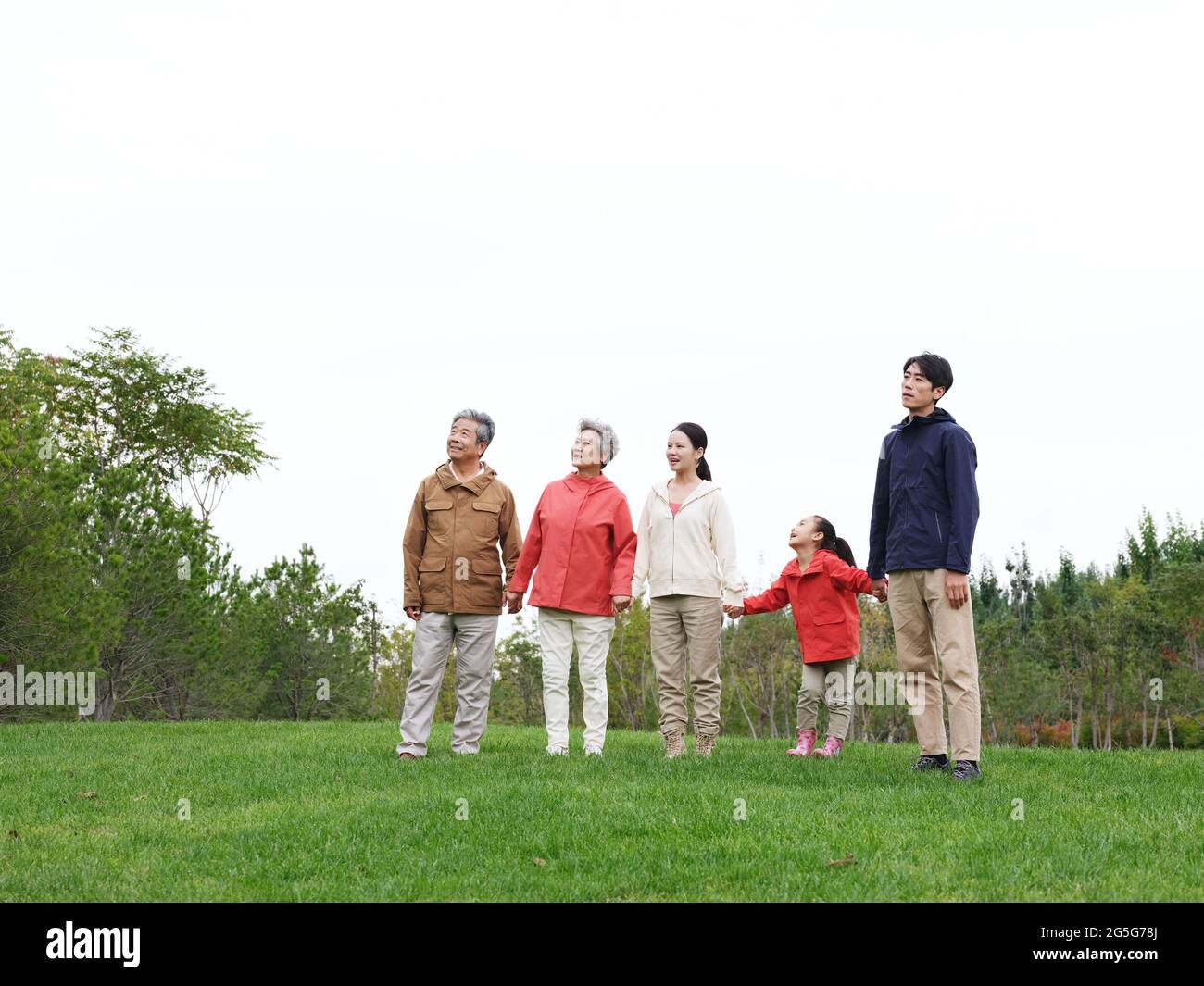 Happy family of five looking at the scenery in the park high quality ...