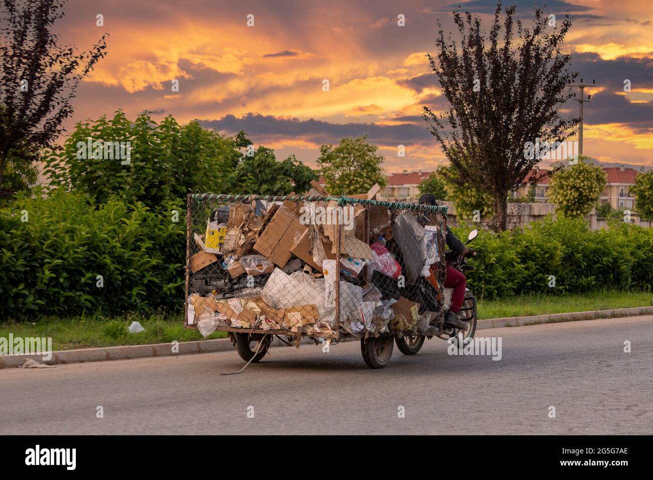 The man who collects garbage with his motorcycle. paper trash Stock ...