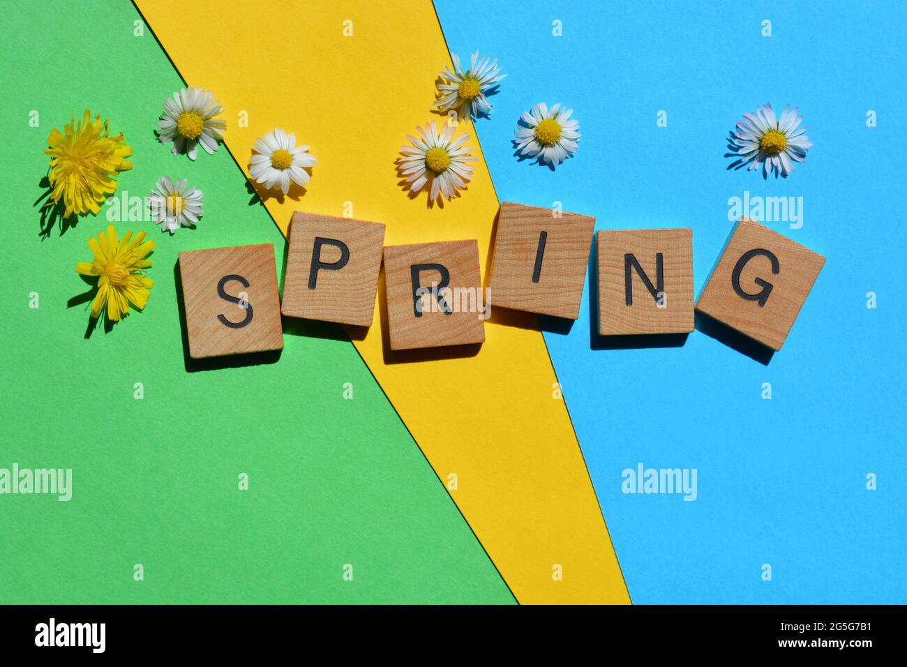 Spring, word in wooden alphabet letters isolated on colourful ...