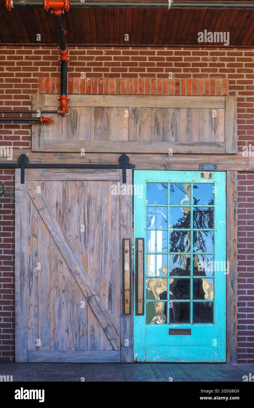 Unique rustic barn door entrance to building with reflection of nature ...