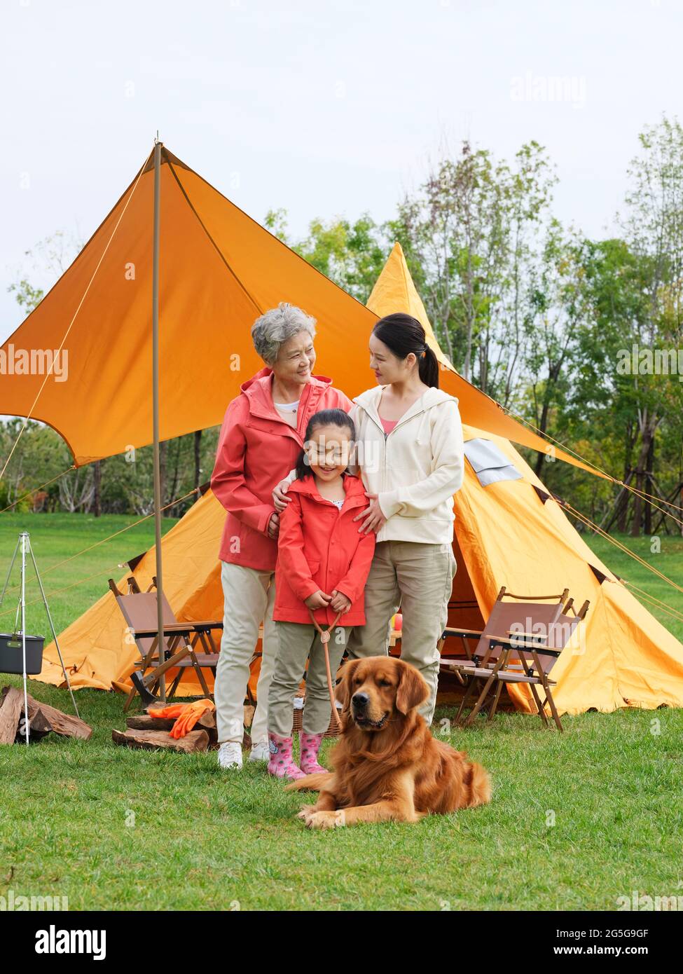 Happy grandparents and grandchildren take a group photo with their pet ...