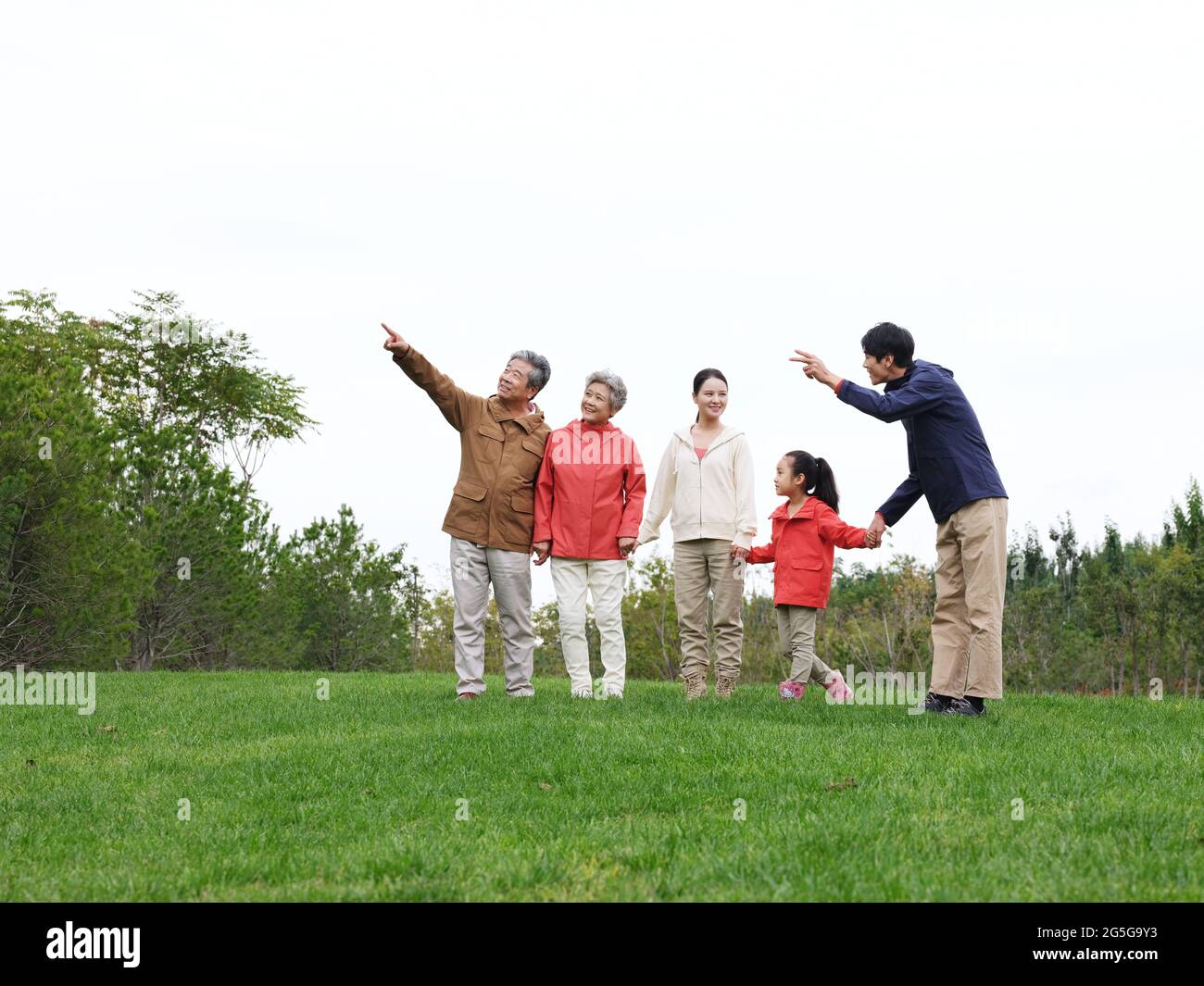 Happy family of five looking at the scenery in the park high quality ...