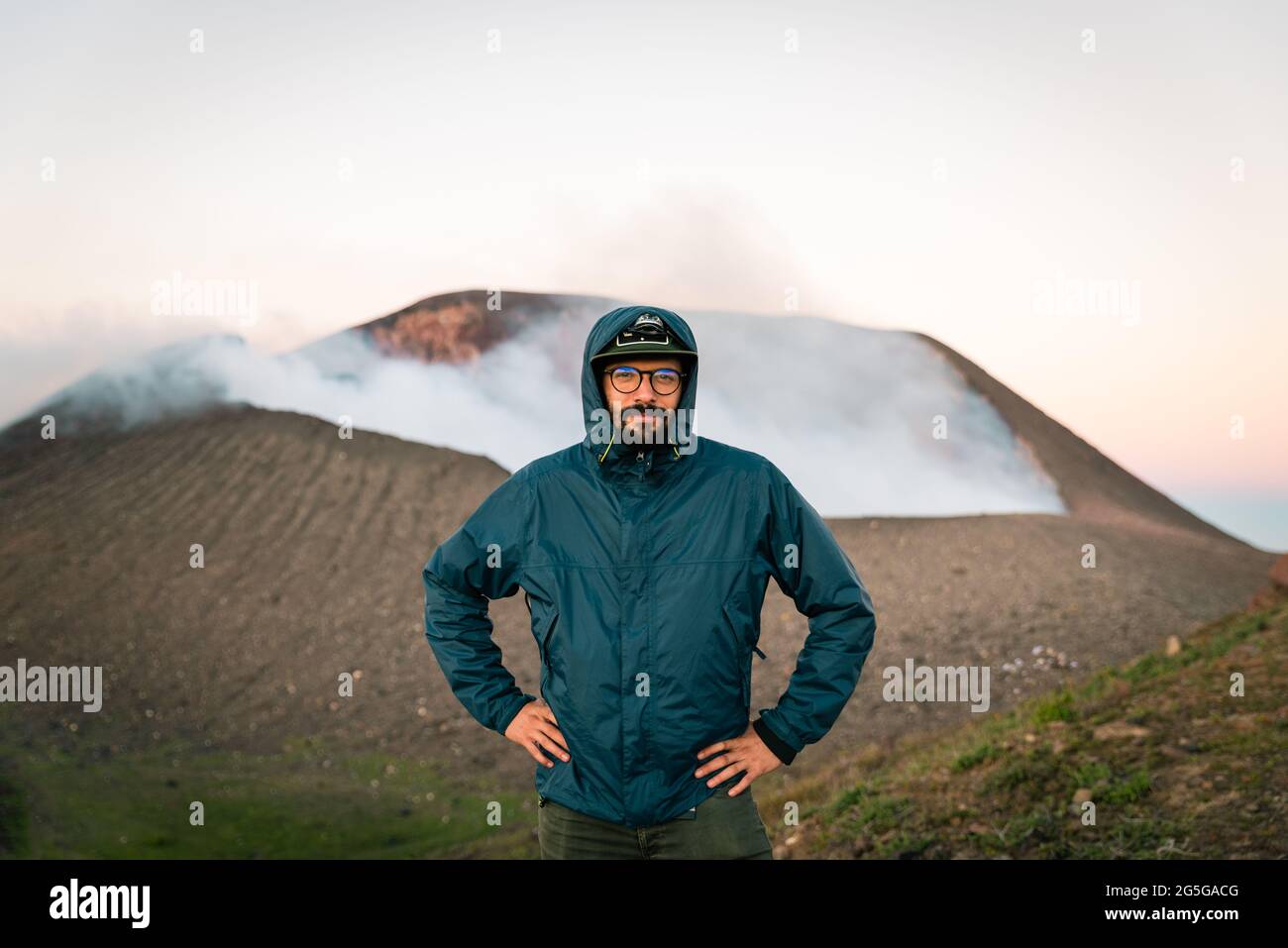 Portrait of a young traveler and explorer man standing in front of an ...