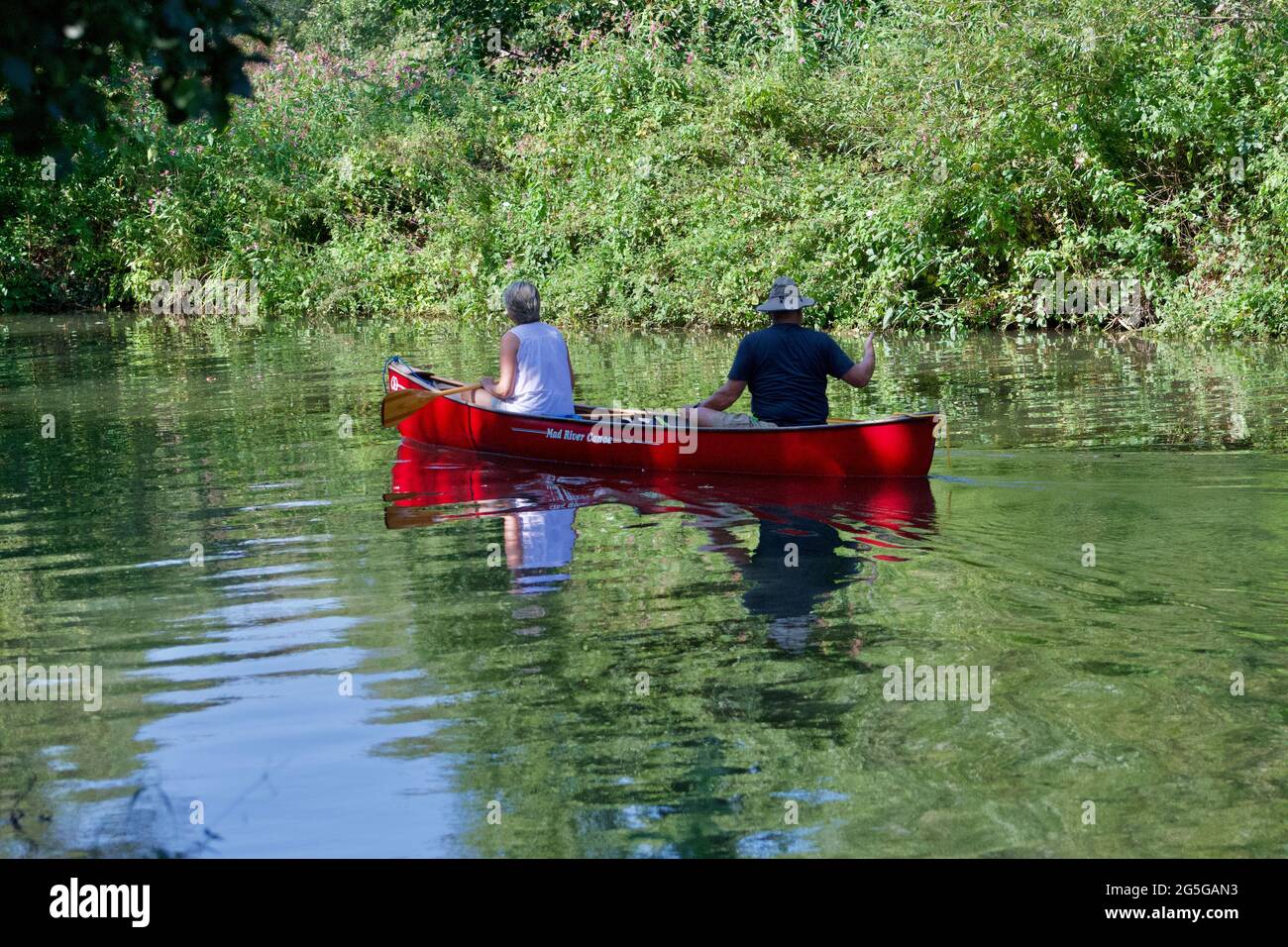 Couple in two man canoe, paddling down the river Stock Photo - Alamy
