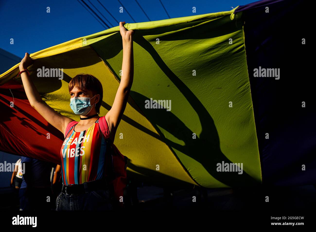 HERMOSILLO, MEXICO - JUNE 26: A person walks while holding a flag ...