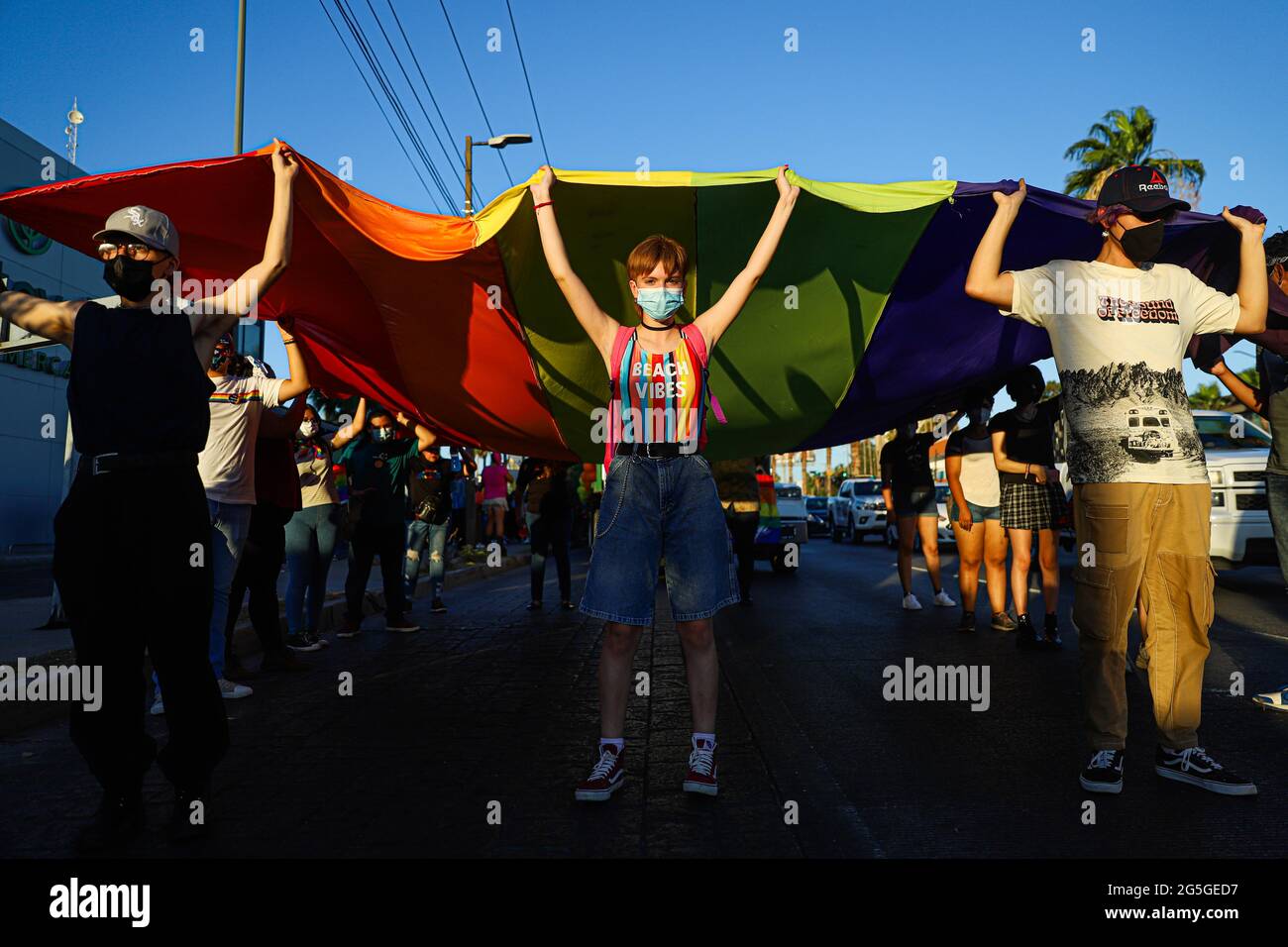 HERMOSILLO, MEXICO - JUNE 26: People carry a large colored flag ...