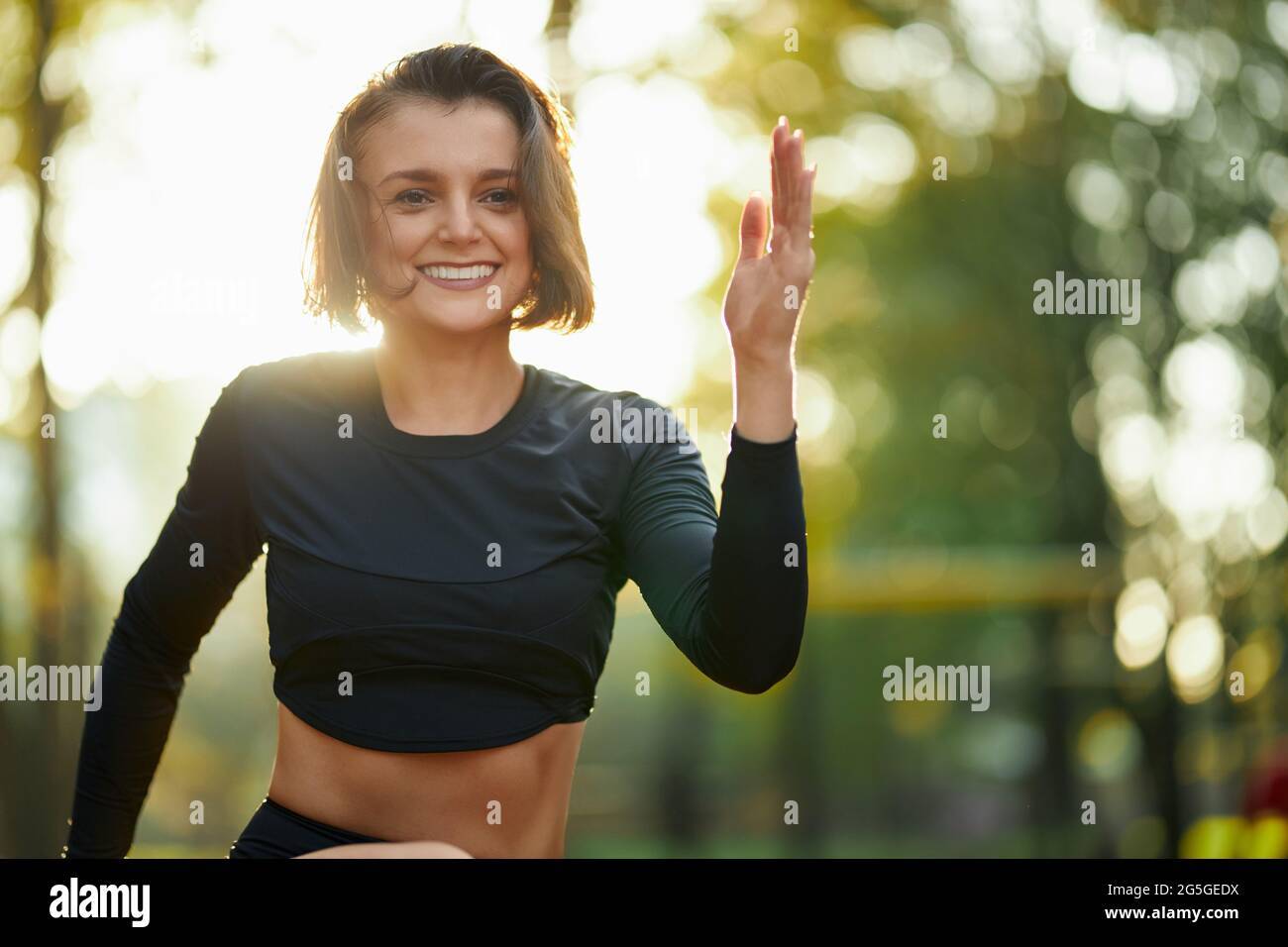 Front view of charming active woman with dark hair doing physical ...