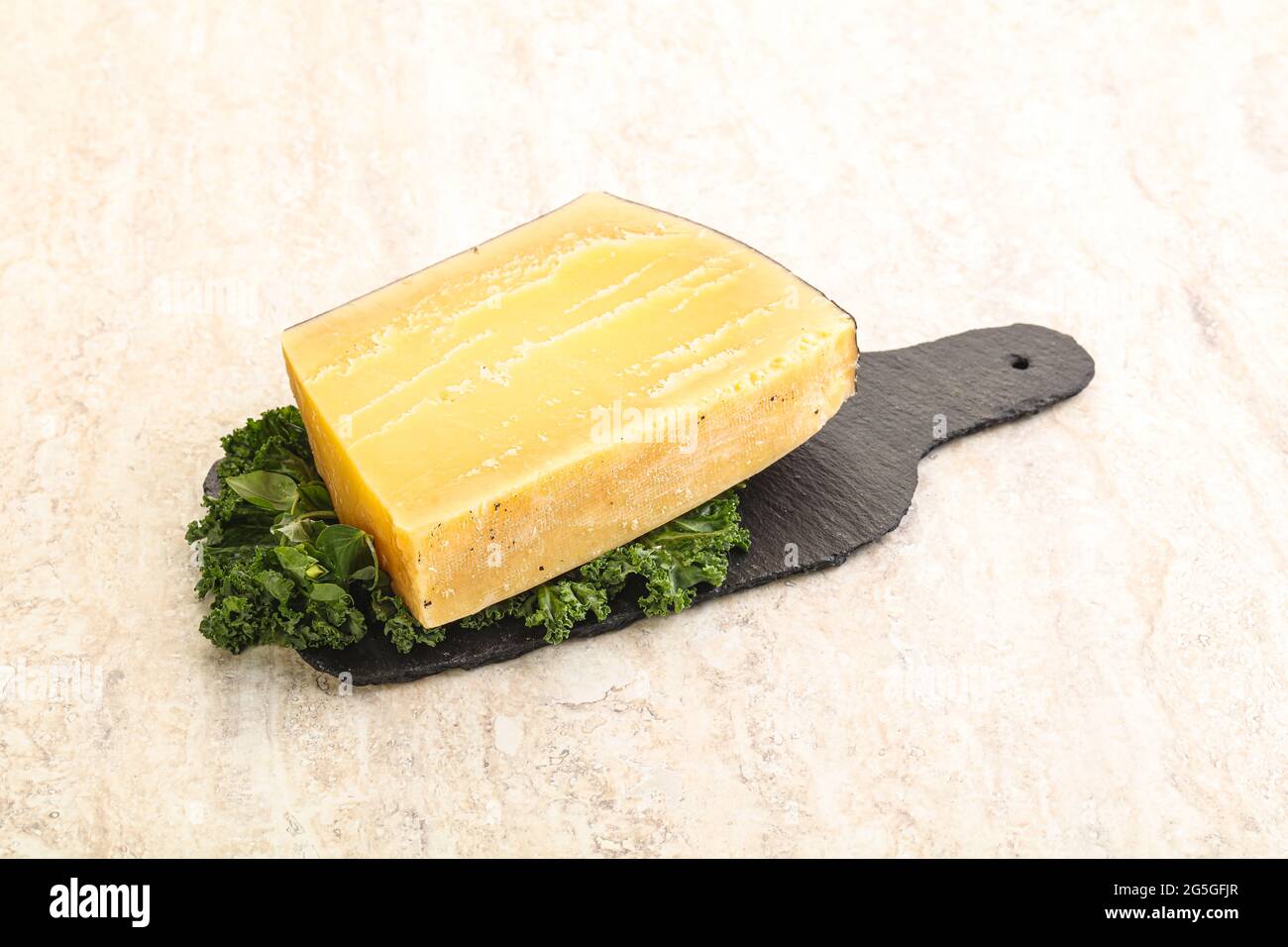 Hard Parmesan cheese piece over board Stock Photo - Alamy