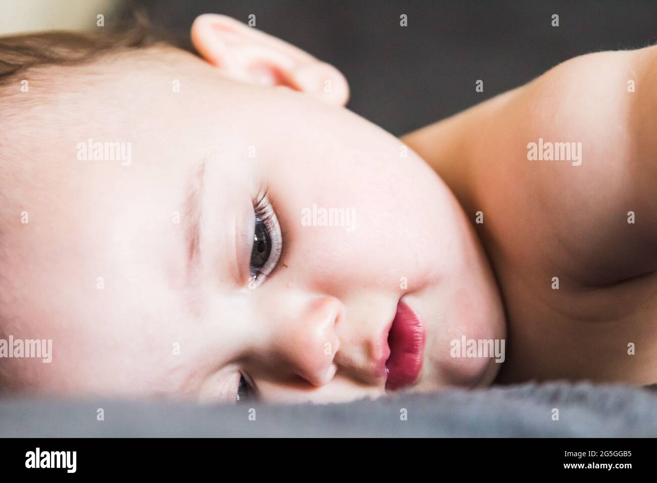 A portrait of adorable baby lying Stock Photo - Alamy