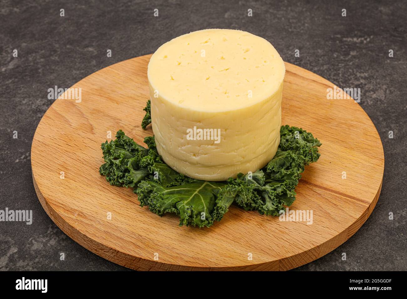 Yellow round dairy soft cheese piece Stock Photo - Alamy