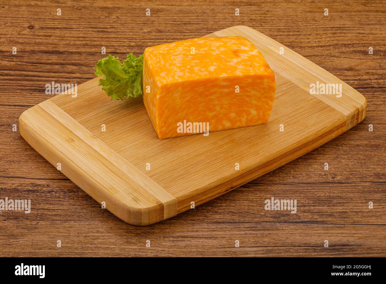 Dairy Marble cheese brick over board Stock Photo - Alamy