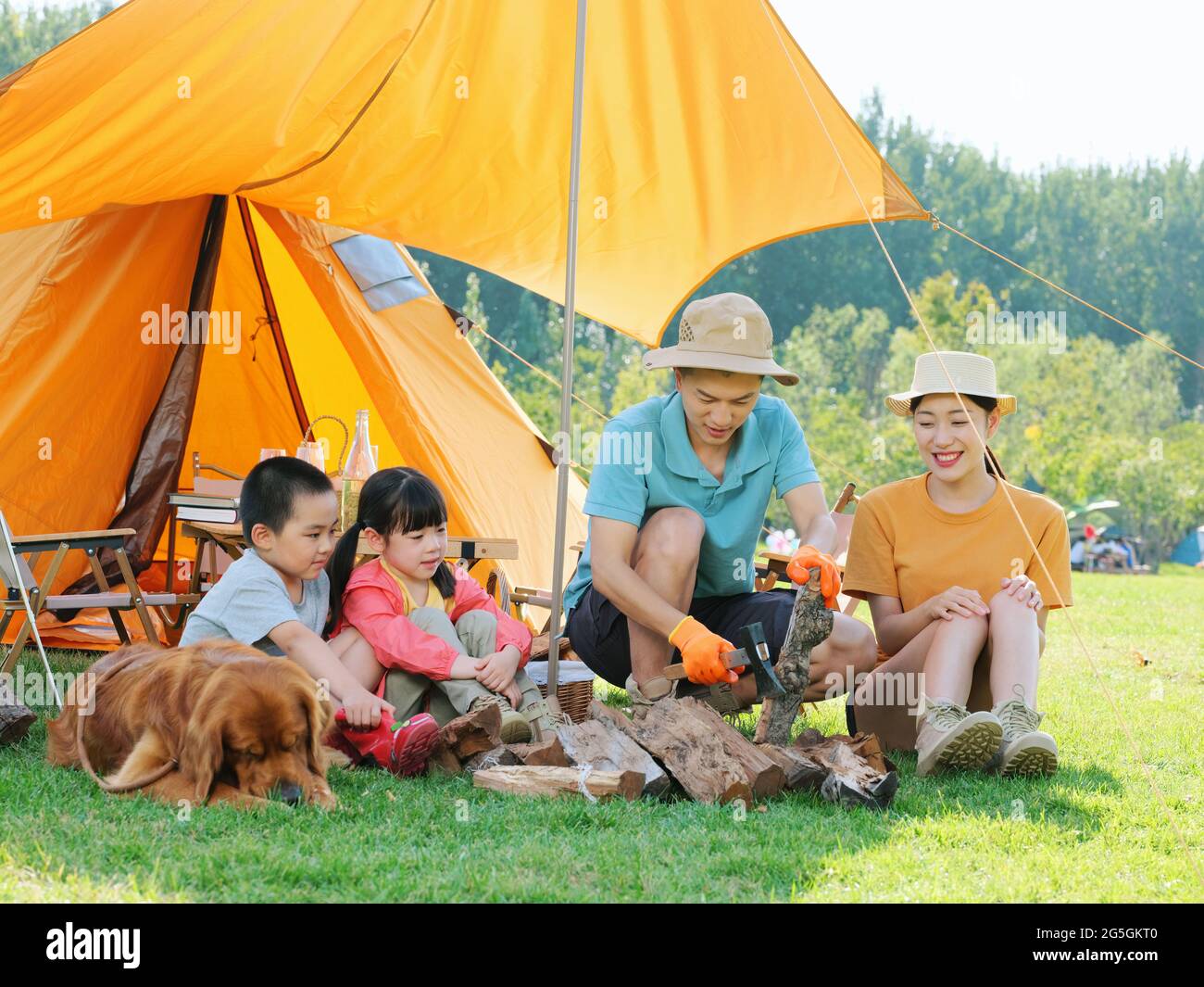 Happy family of four and dog camping out high quality photo Stock Photo ...