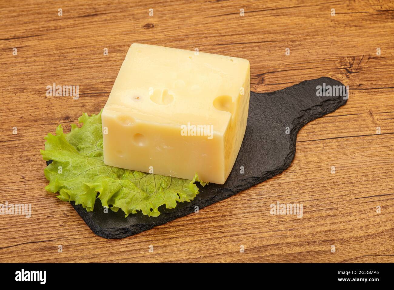 Emmental cheese over wooden board served salad Stock Photo - Alamy