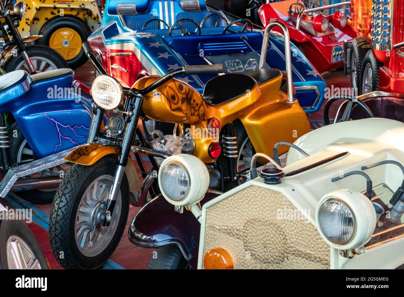 Motorcycle and cars of vehicle merry-go-round amusement ride in ...