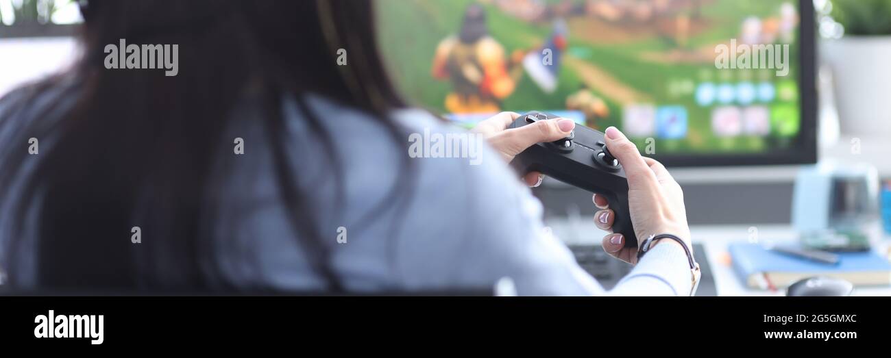 Woman with remote control in hands playing video game Stock Photo - Alamy