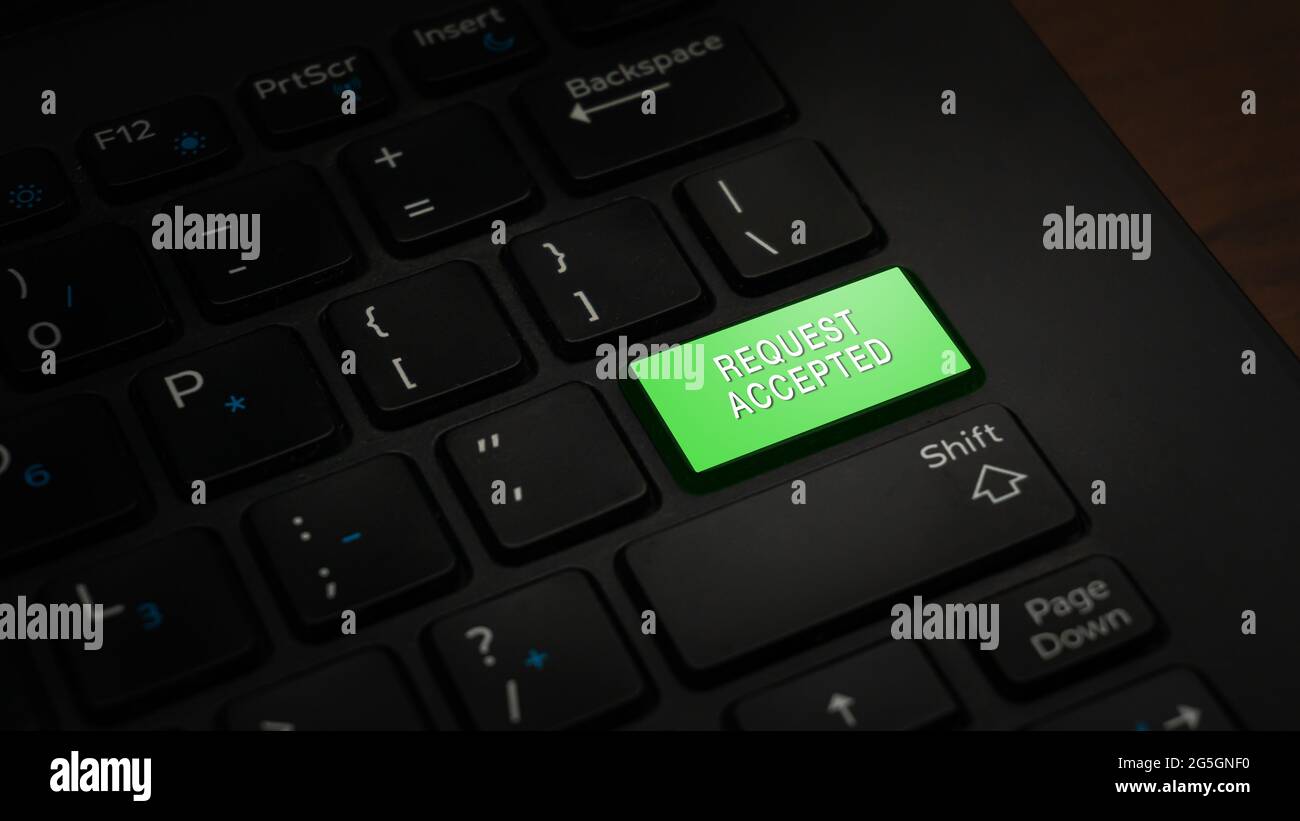 a REQUEST ACCEPTED button with green color on a black laptop keyboard ...