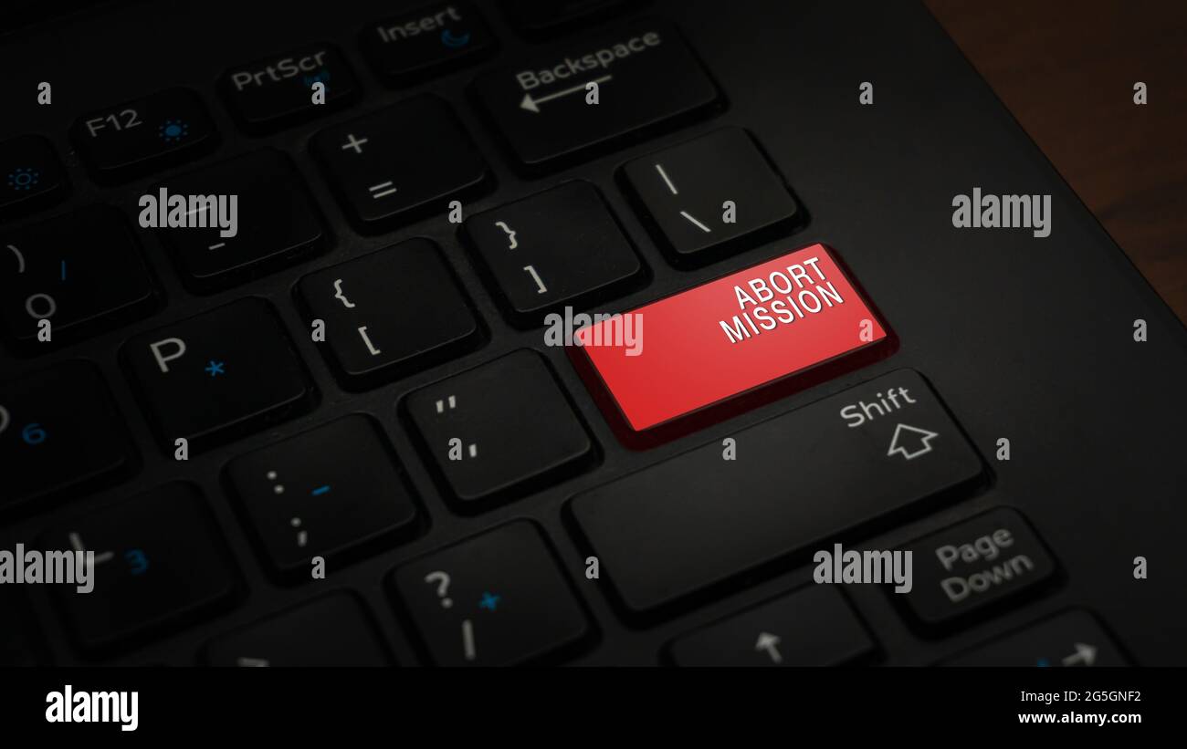 a red ABORT MISSION button on a black keyboard background - terminate ...