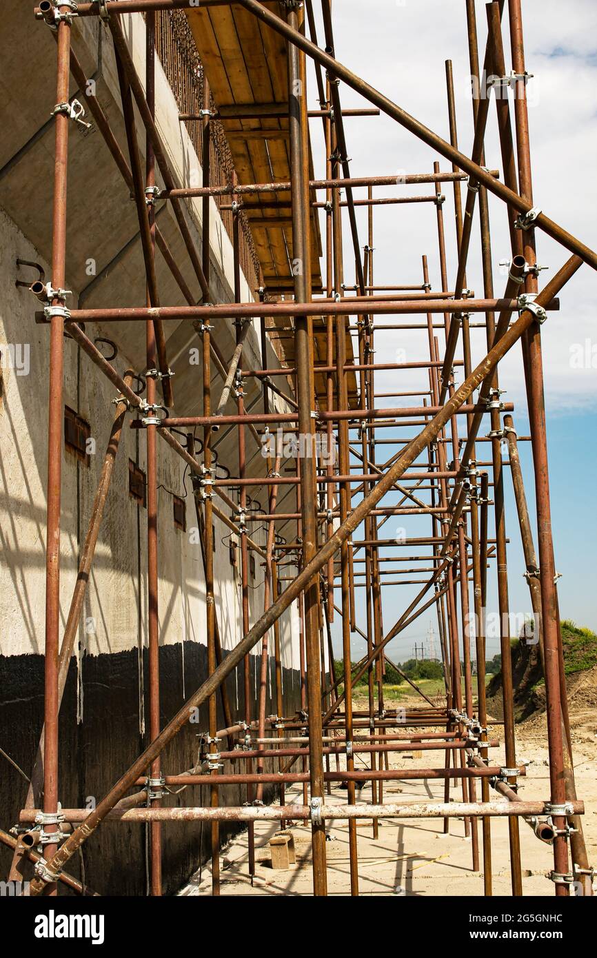 Construction site with scaffolding tower and building. Scaffolding for ...