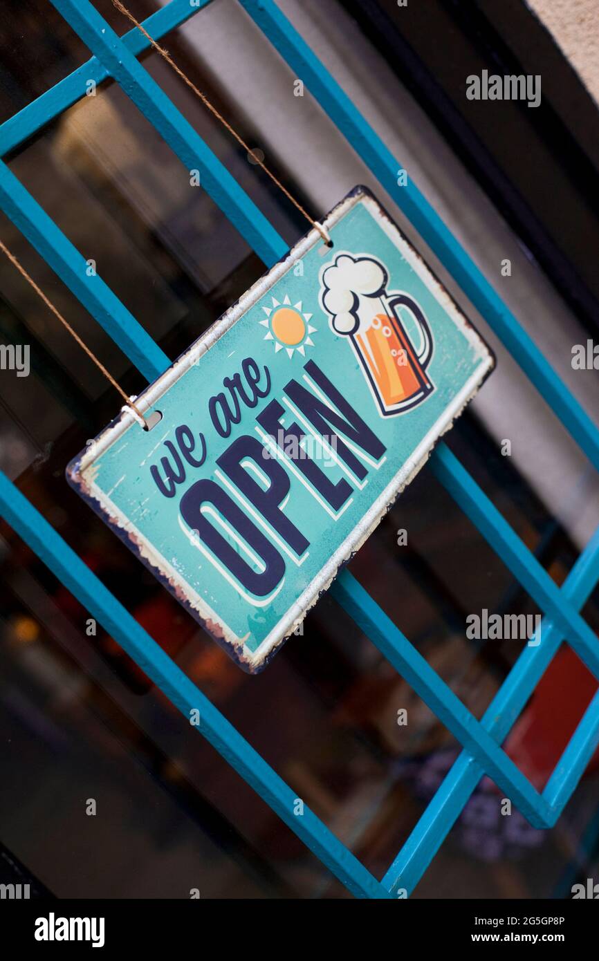 Open sign on the gate of a pub Stock Photo - Alamy