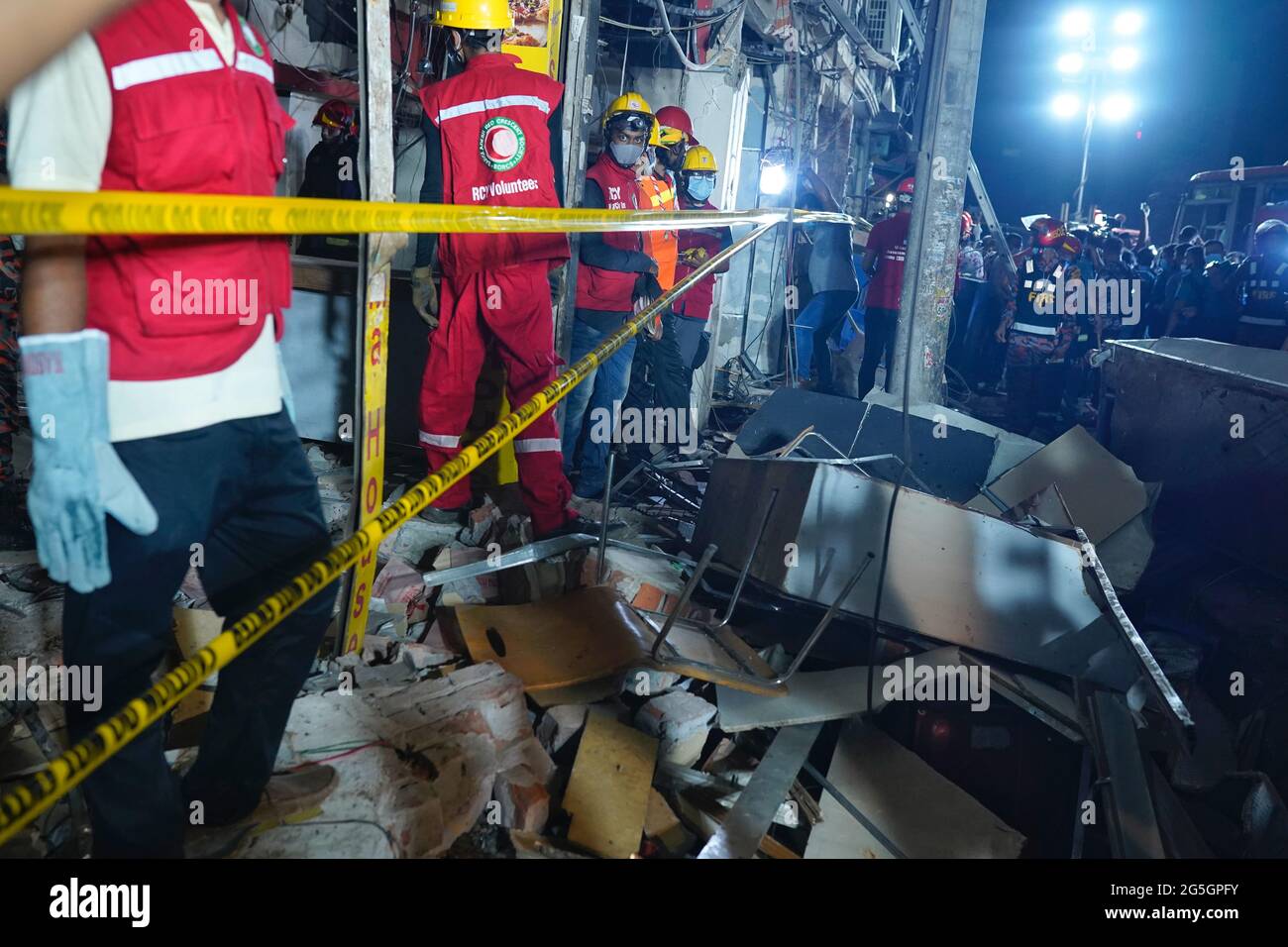 Dhaka, Bangladesh. 27th June, 2021. Firefighters inspect the scene ...