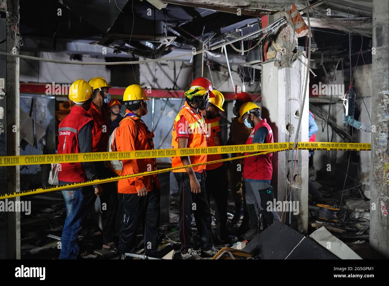 Firefighters inspect the scene after a suspected gas explosion at ...