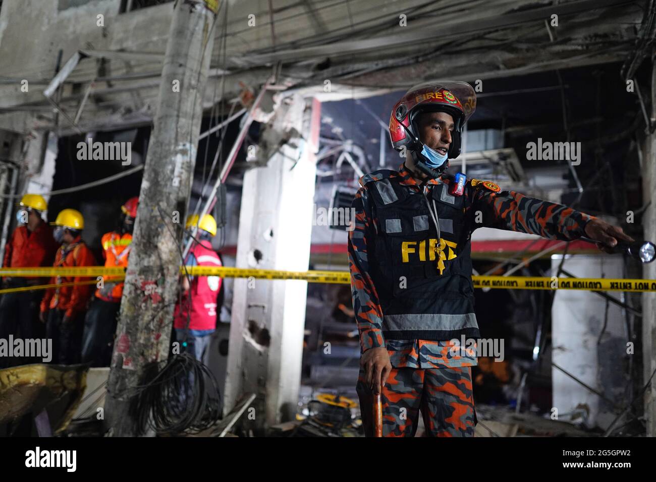 Dhaka, Bangladesh. 27th June, 2021. Firefighters inspect the scene ...