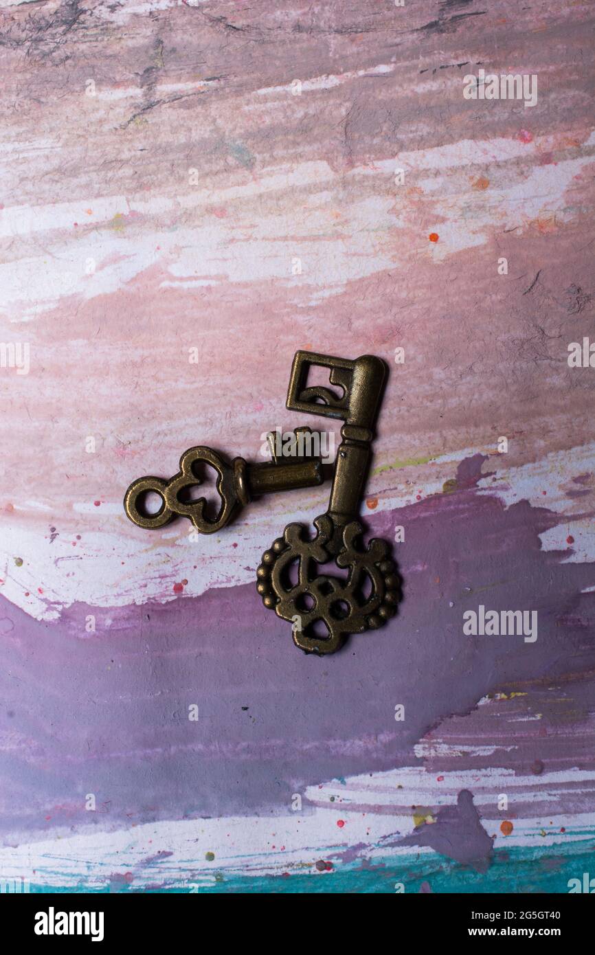 A vertical top view of metal keys on a colorful surface Stock Photo - Alamy