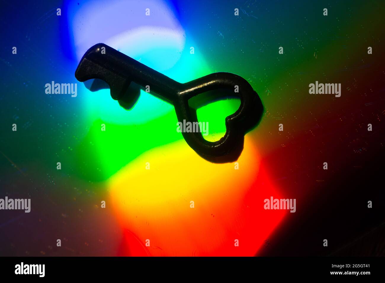 A top view of a metal heart-shaped key on a colorful surface Stock ...