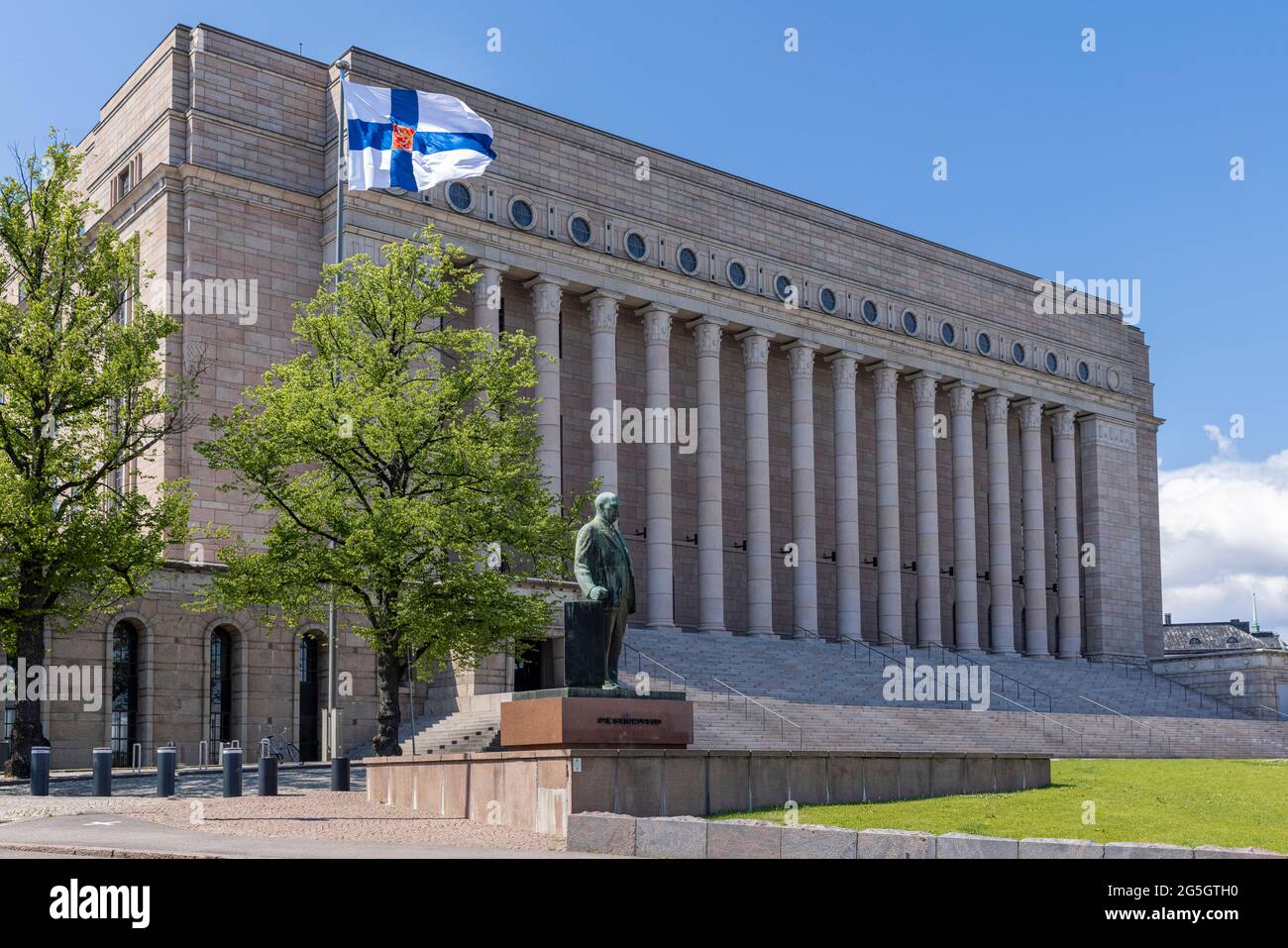 State flag flying in front of Finnish pariament building in Helsinki ...