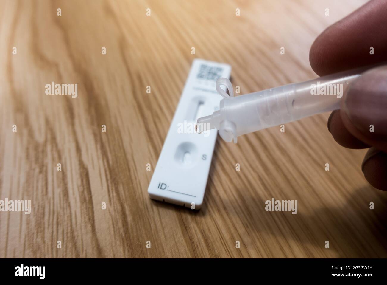 Lateral flow test liquid dropped into the test kit by adult male Stock ...