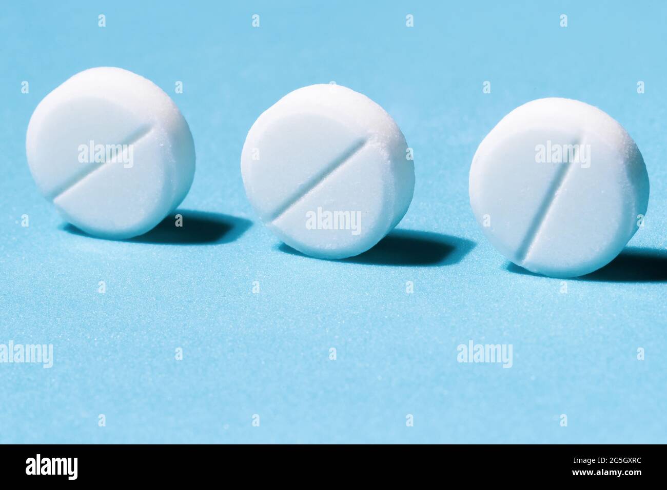 close up. three round tablets on a blue background Stock Photo - Alamy