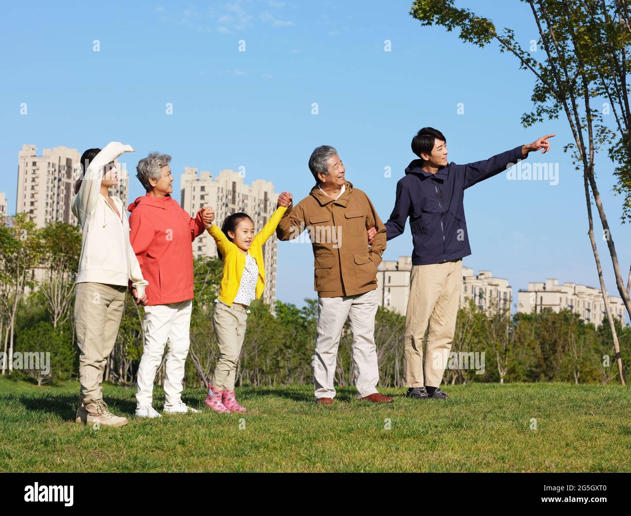 Happy family of five looking at the scenery in the park high quality ...