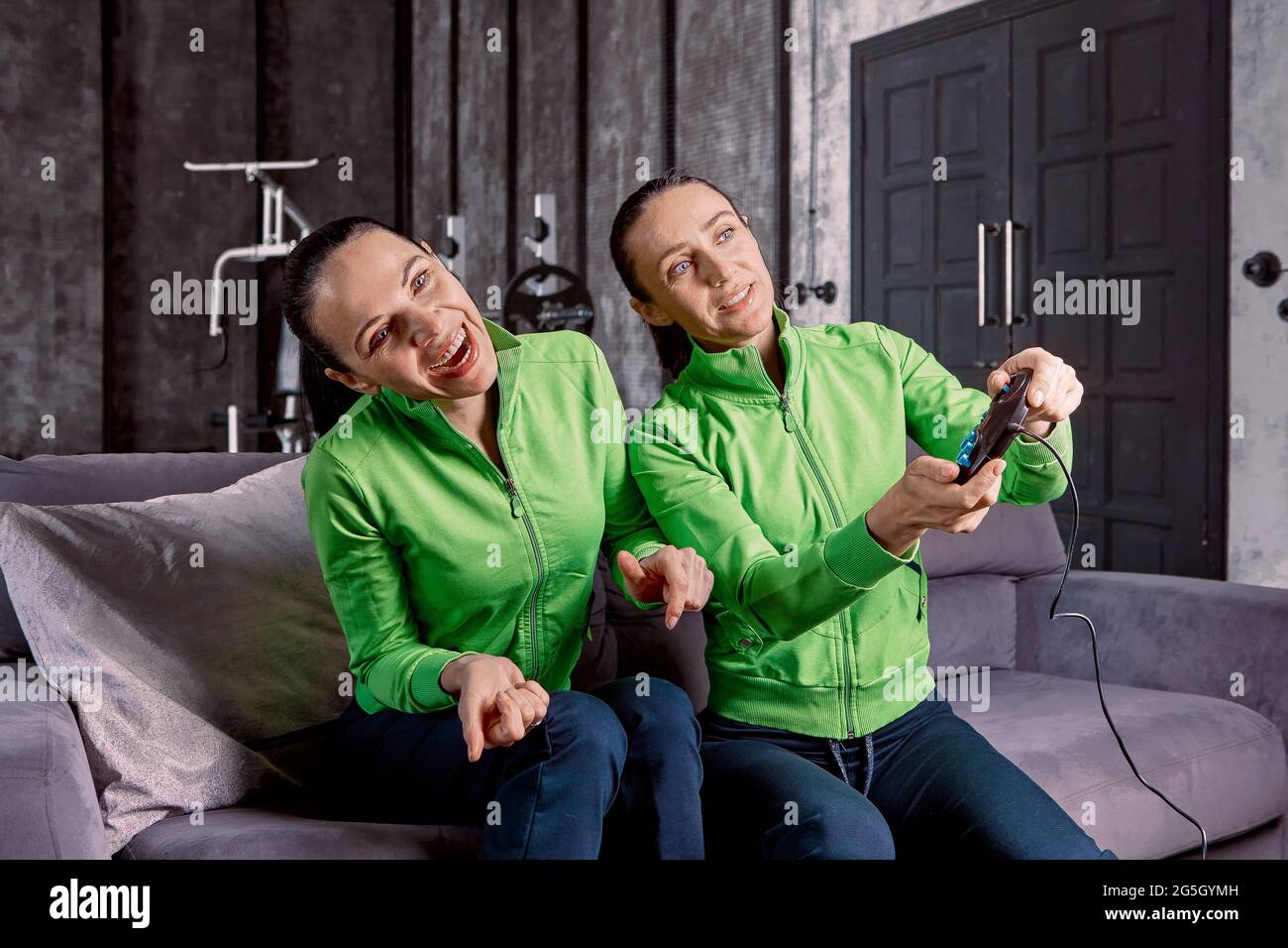 Mature women play video games in loft apartment Stock Photo - Alamy