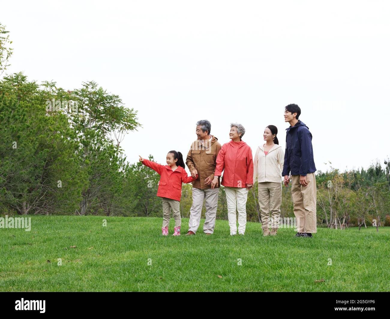 Happy family of five looking at the scenery in the park high quality ...