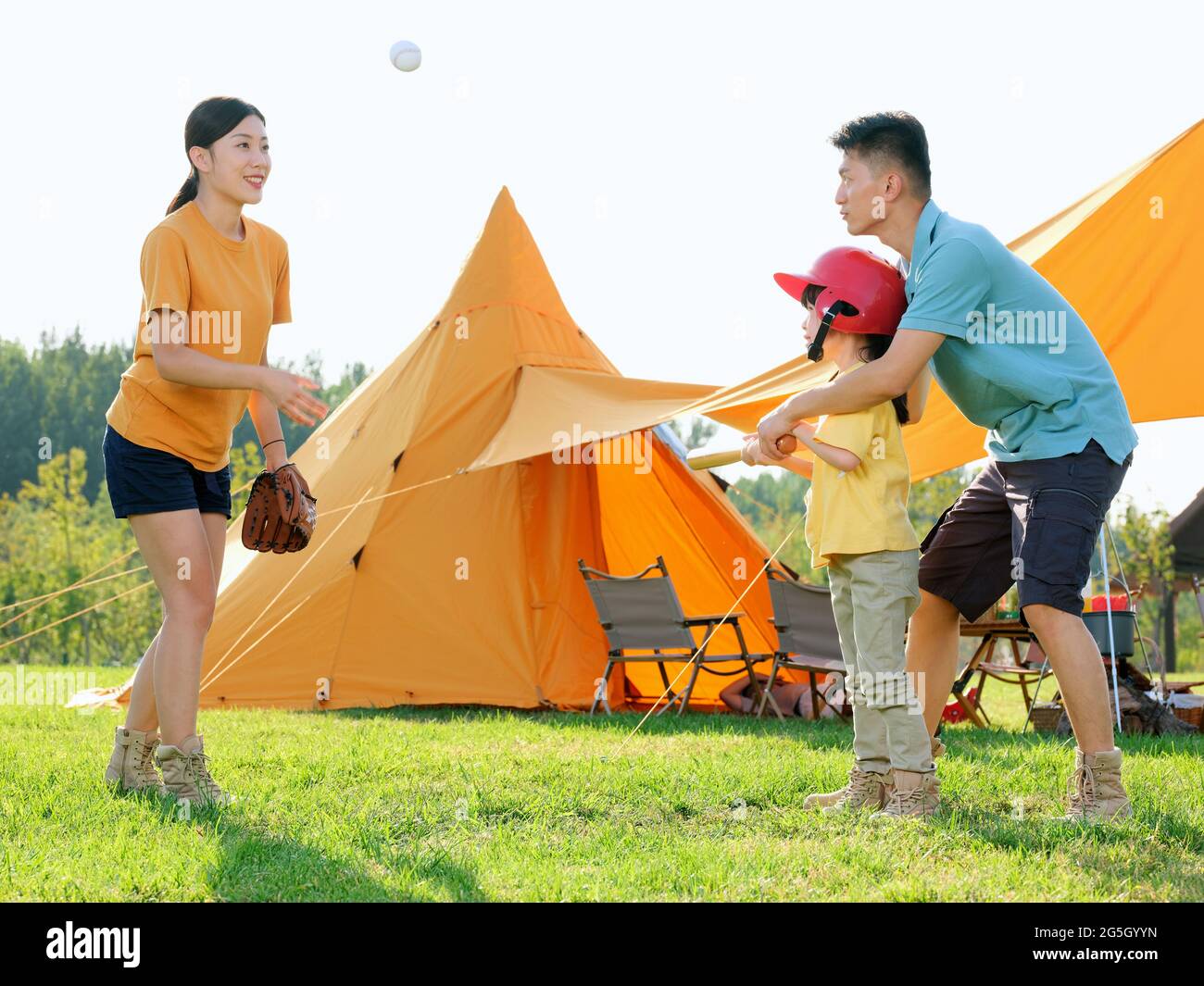 Happy family of three playing baseball in the park high quality photo ...