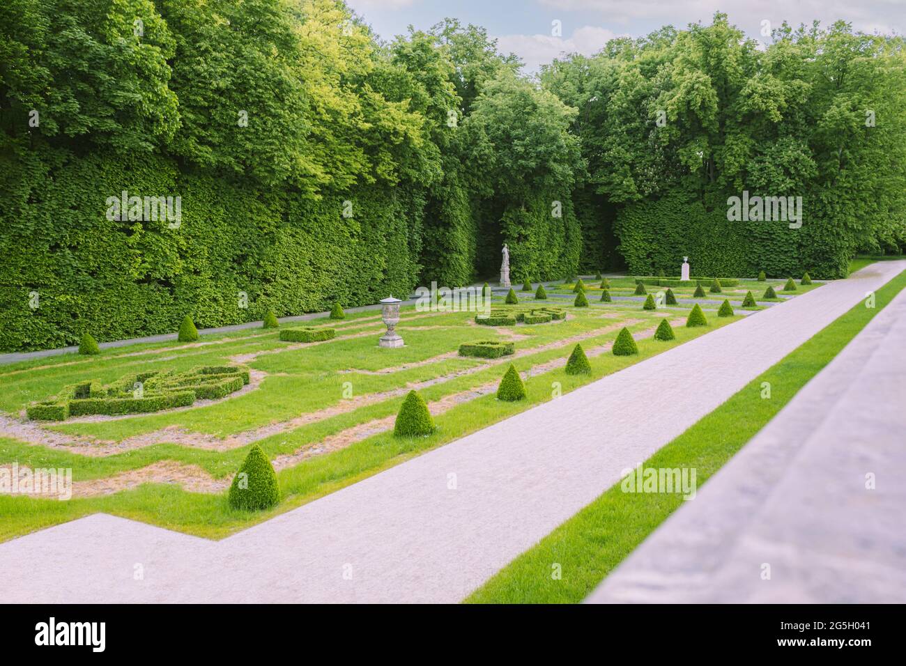 A beautiful landscape of a city park with paths, flower beds and trees ...