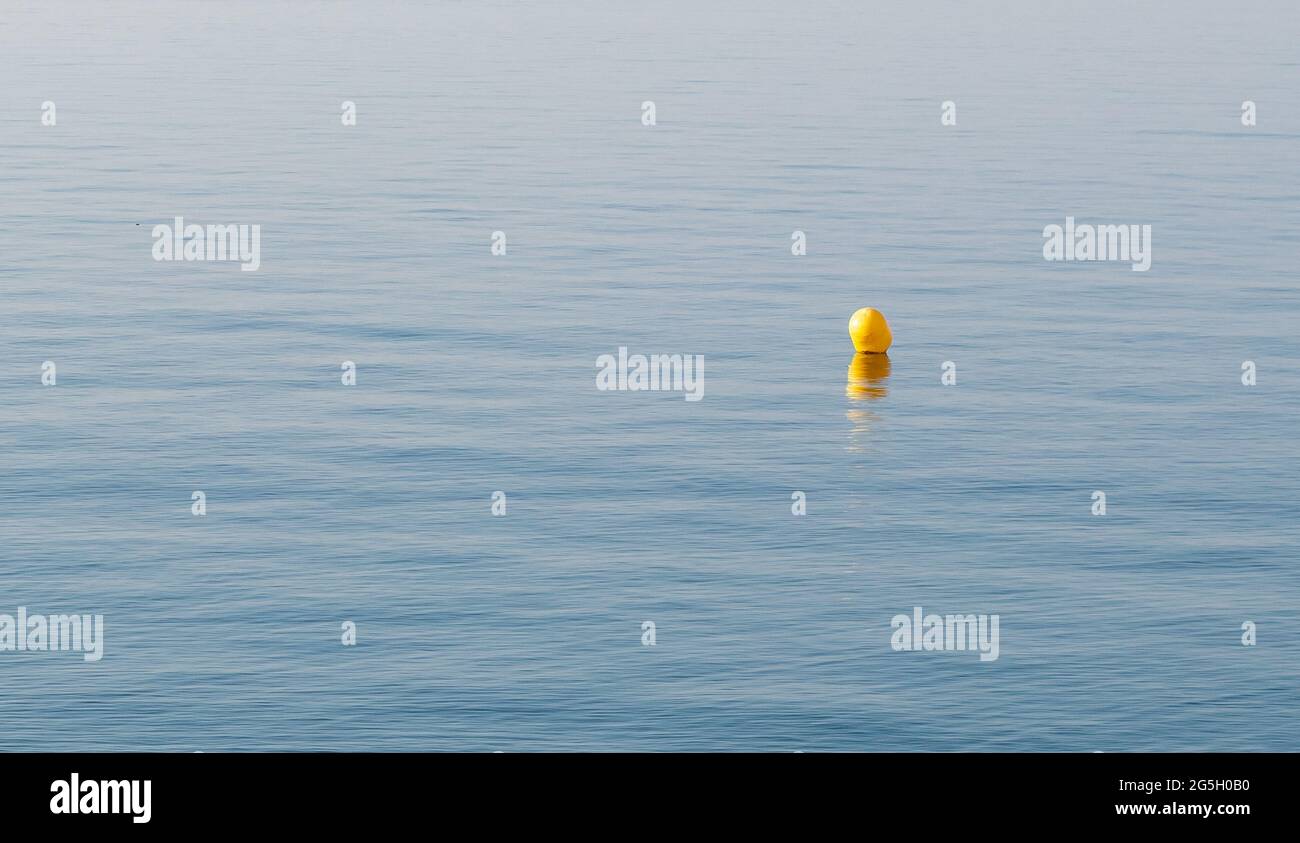 A yellow float ball on the water for wallpaper and background Stock ...