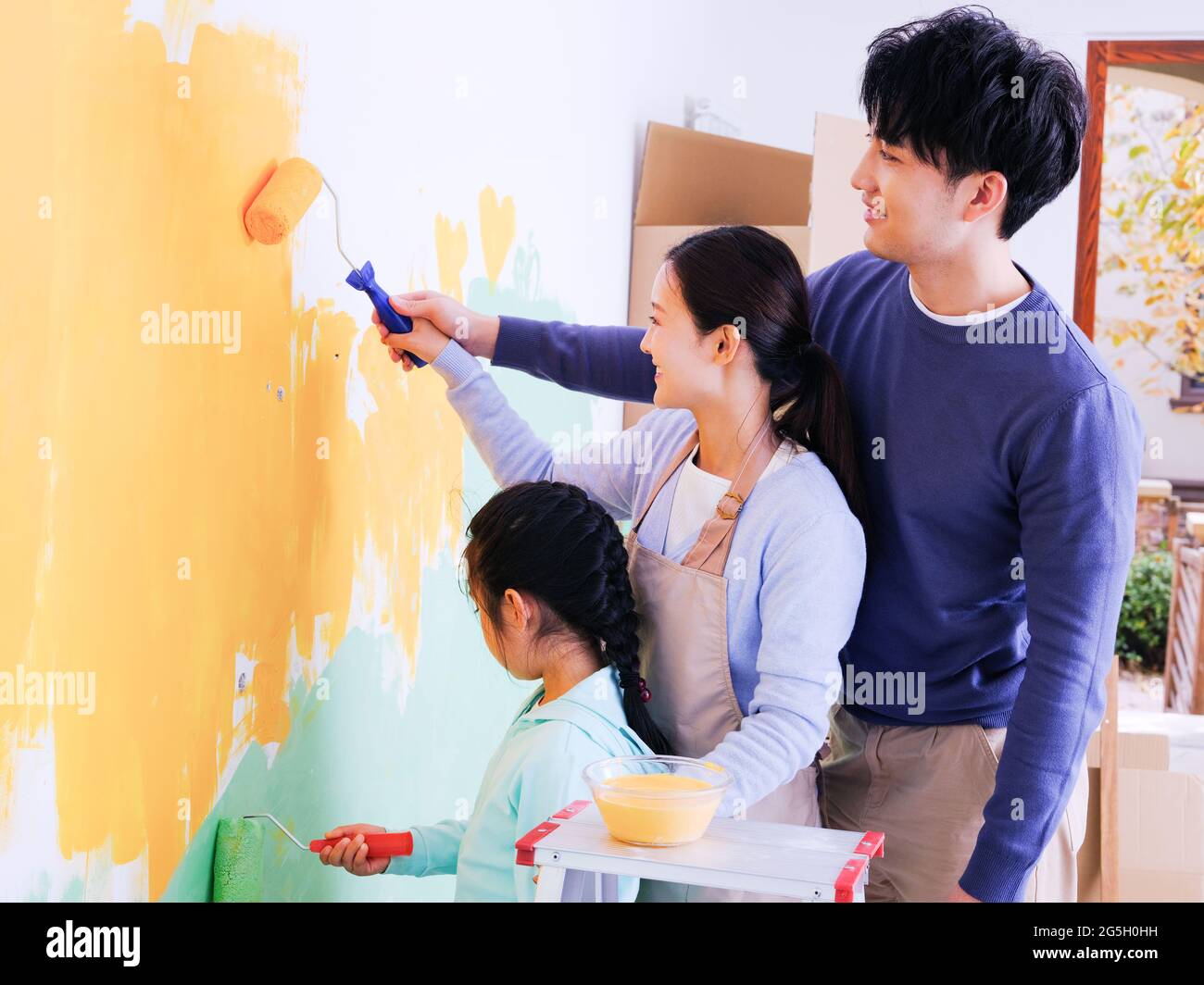 A happy family of three painting walls high quality photo Stock Photo ...